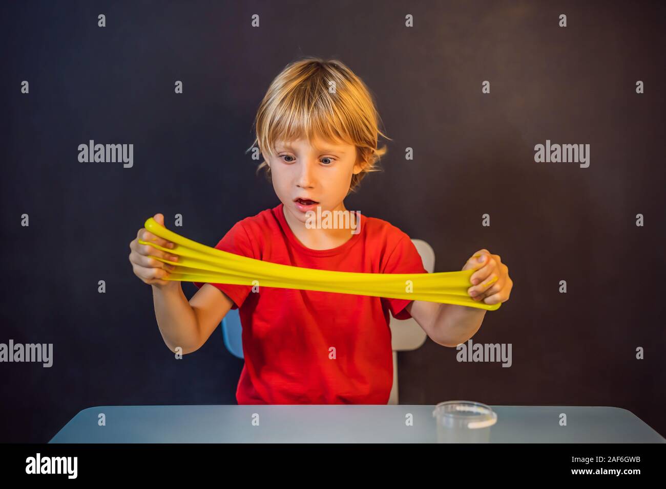 Boy playing hand made toy called slime. Child play with slime. Kid ...