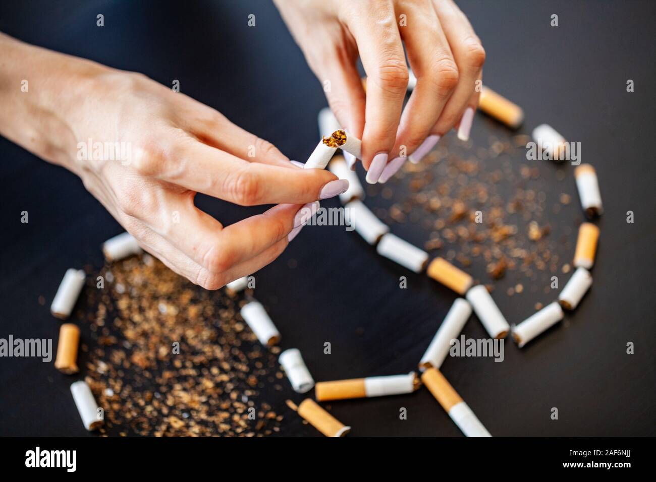 Stop smoking concept on background with broken cigarettes. Heap of ...