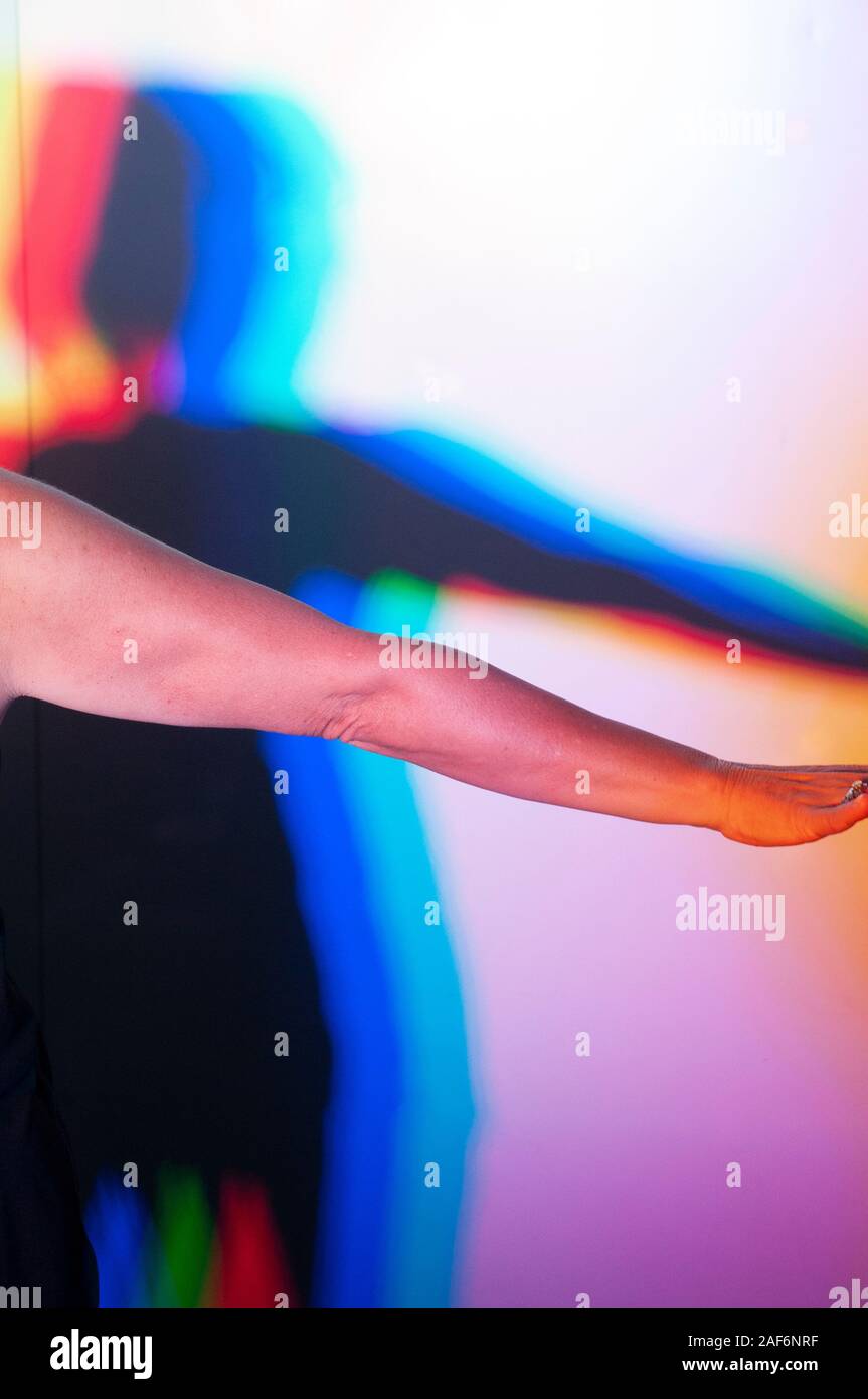 Art project. Color lights are projected onto a reflective screen the ...