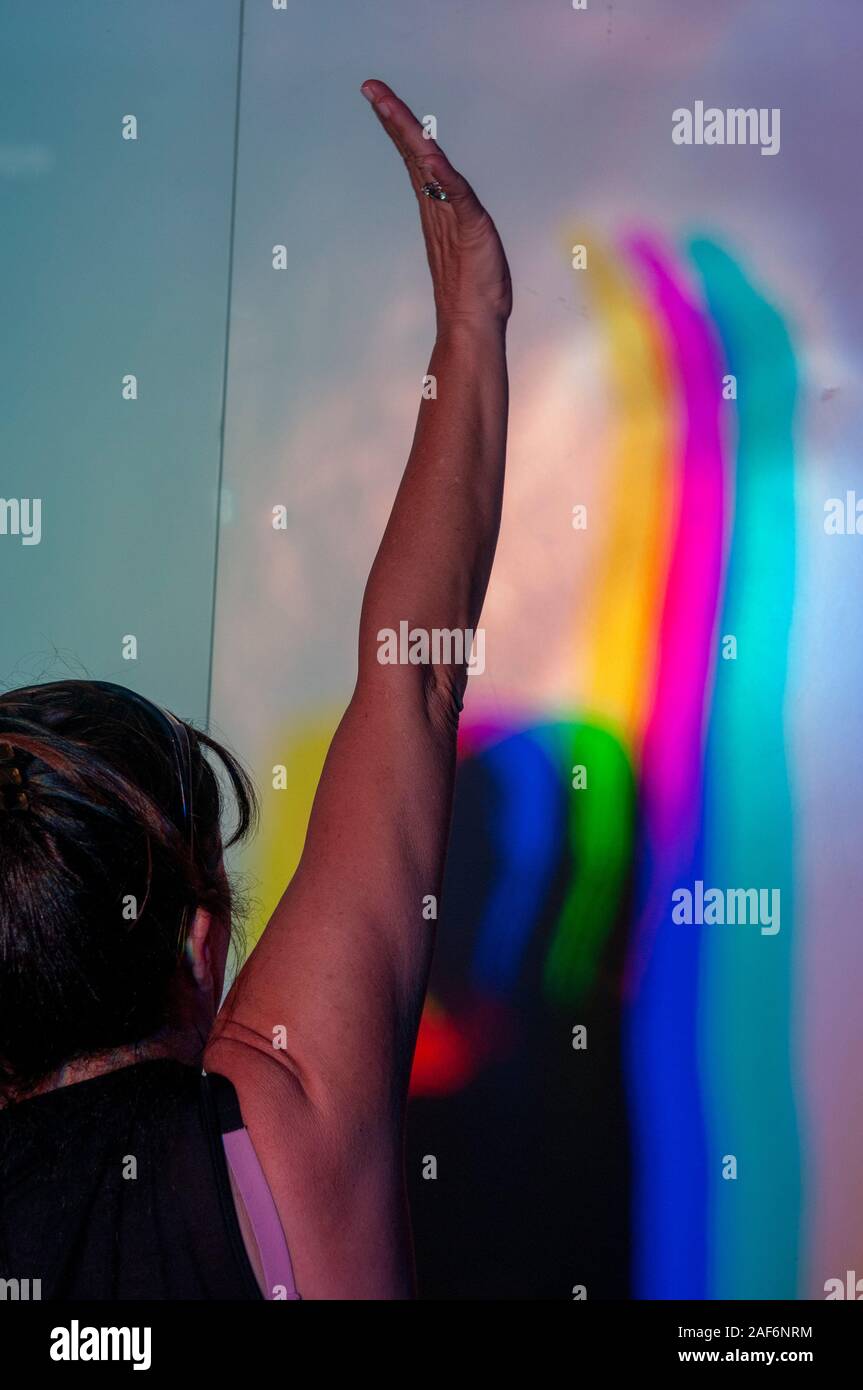Art project. Color lights are projected onto a reflective screen the ...