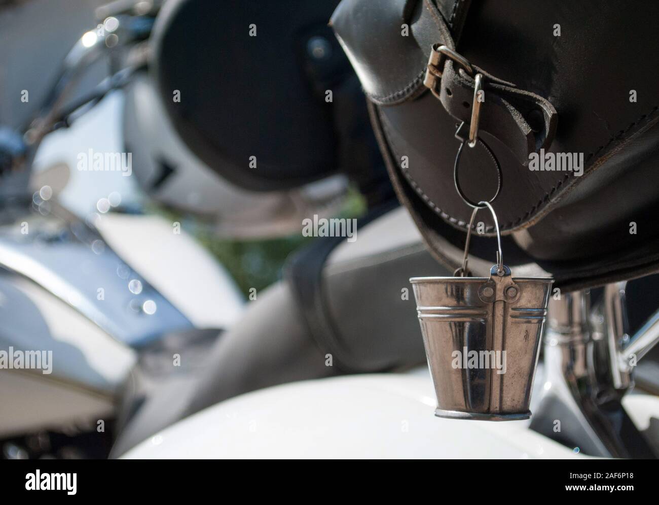 tiny bucket hanging on the motorcycle's bag Stock Photo - Alamy