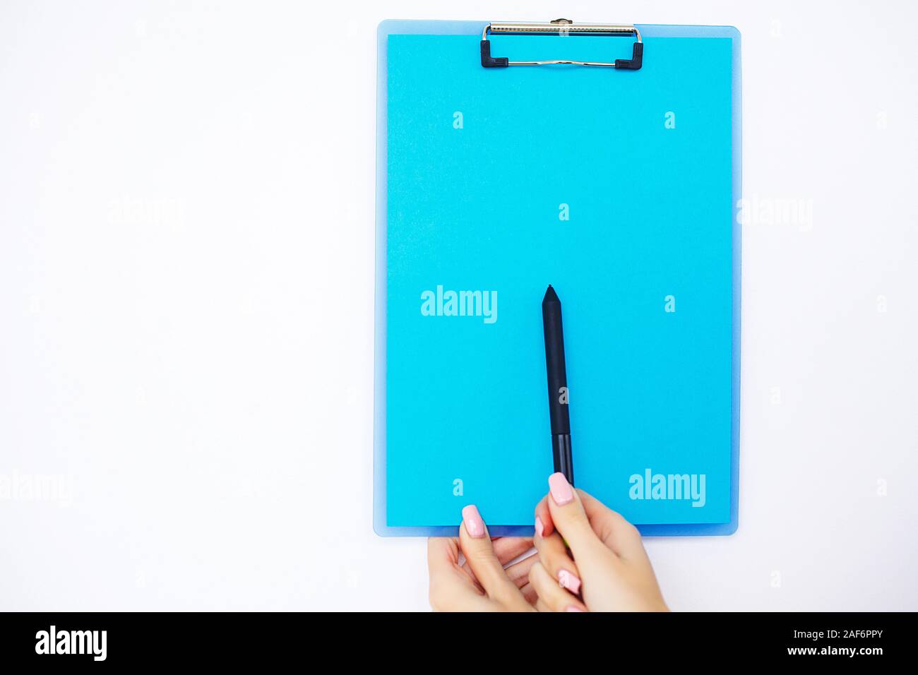 Blank Folder with Blue Paper. Hand that Holding Folder and Pen on White ...