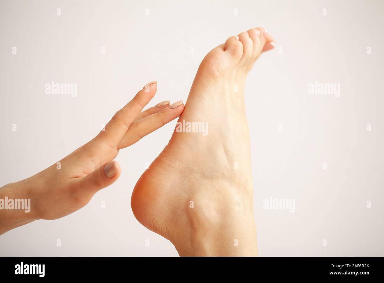 Woman's french pedicure. Close Up Woman Hands Touching Long Legs, Soft ...