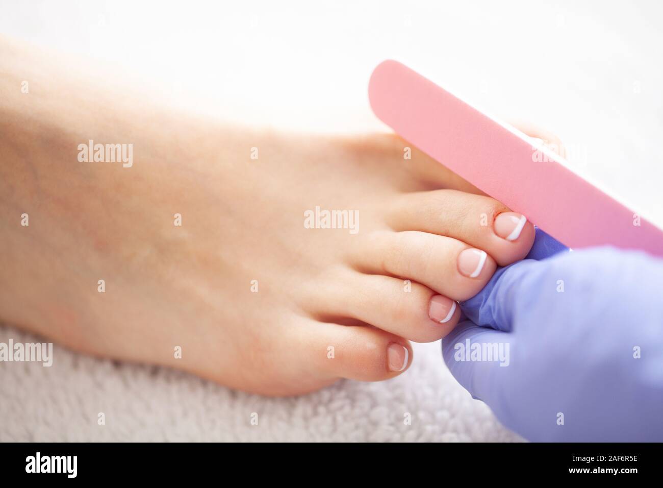 Close Up photo of a female feet at spa salon on pedicure procedure ...