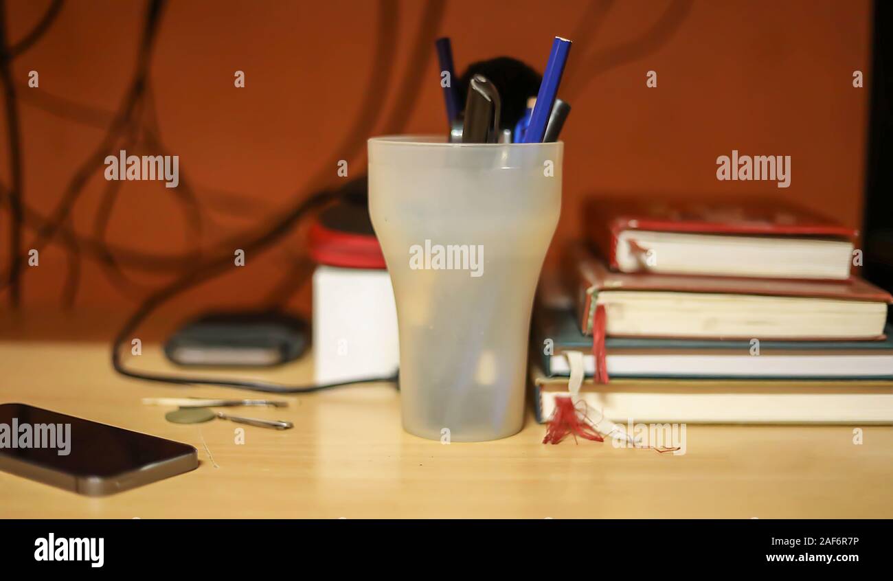 study table desk with books and pencil bucket, mobile phones Stock ...