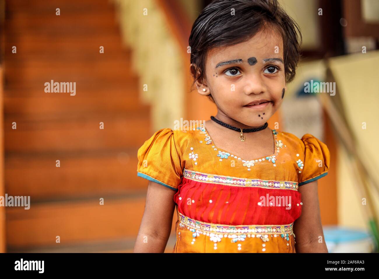 child little girl standing at home against stairs Stock Photo - Alamy