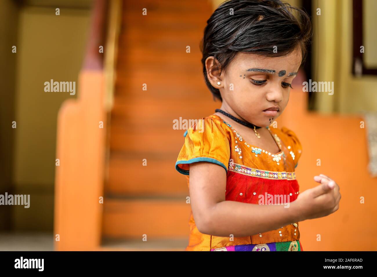 child little girl standing at home against stair Stock Photo - Alamy