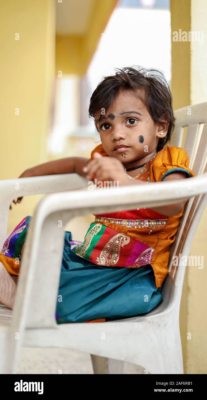 child little girl sitting chair at home Stock Photo - Alamy