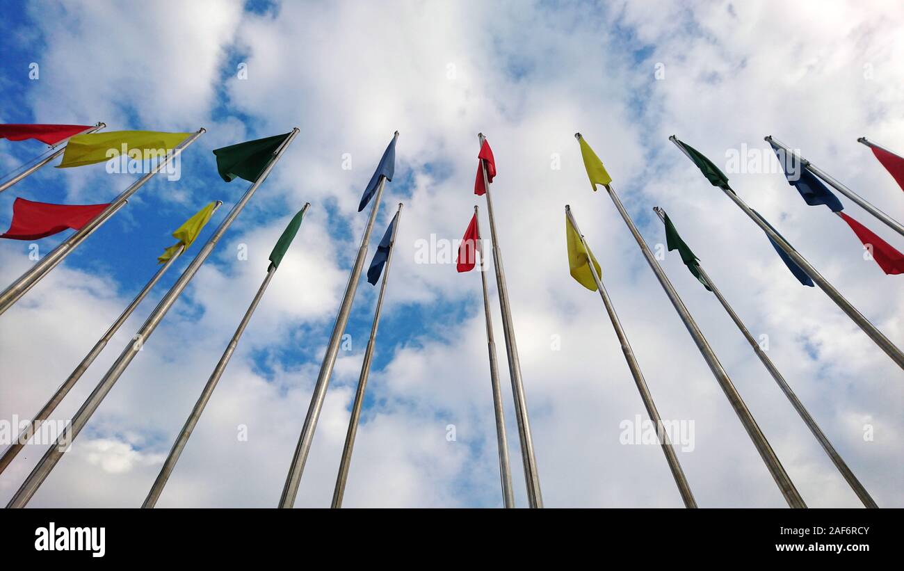 Colorful flags under the blue sky and white clouds Stock Photo - Alamy