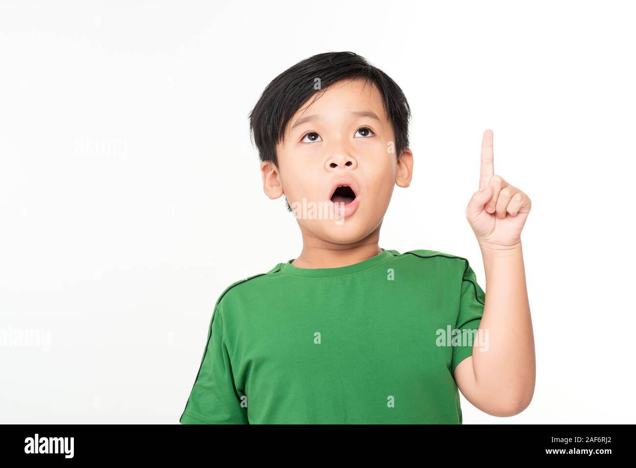 Cheerful little boy pointing up over white background Stock Photo - Alamy