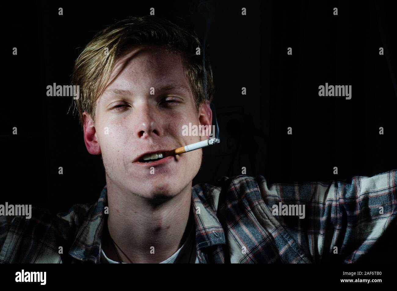 Crazy smoking man looking at the camera while having a cigarette Stock ...