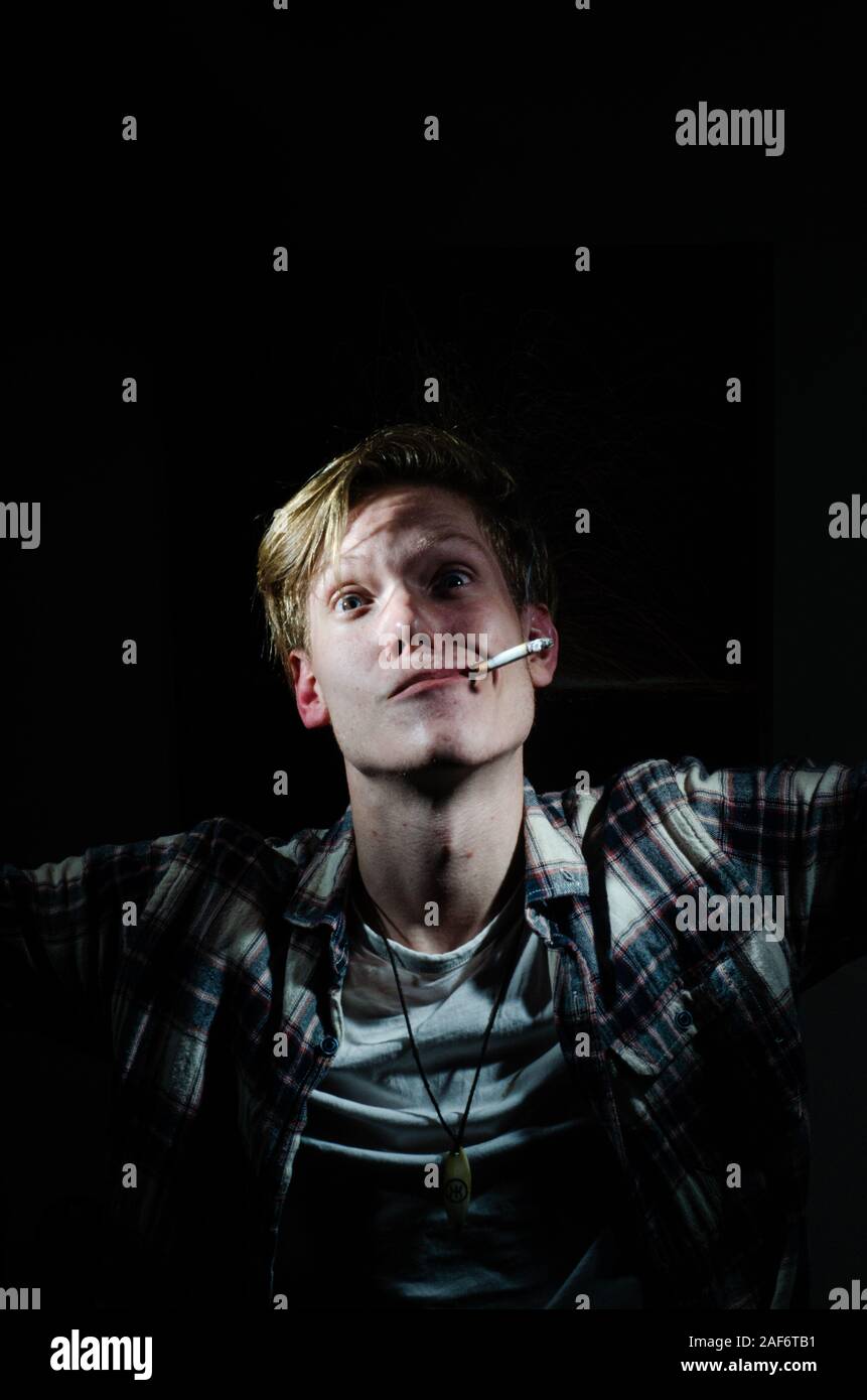 Crazy smoking man looking at the camera while having a cigarette Stock ...