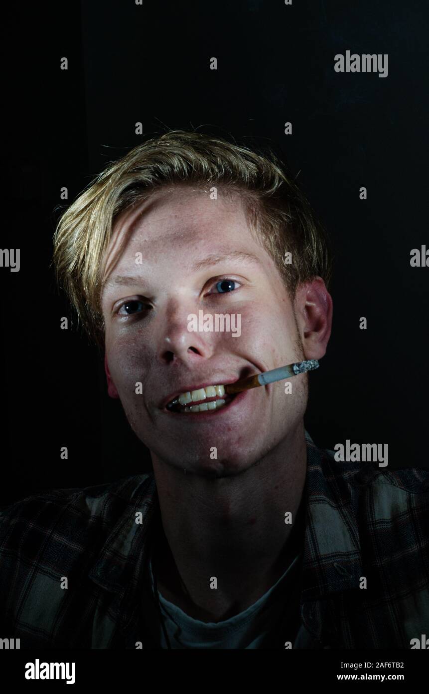 Crazy smoking man looking at the camera while having a cigarette Stock ...