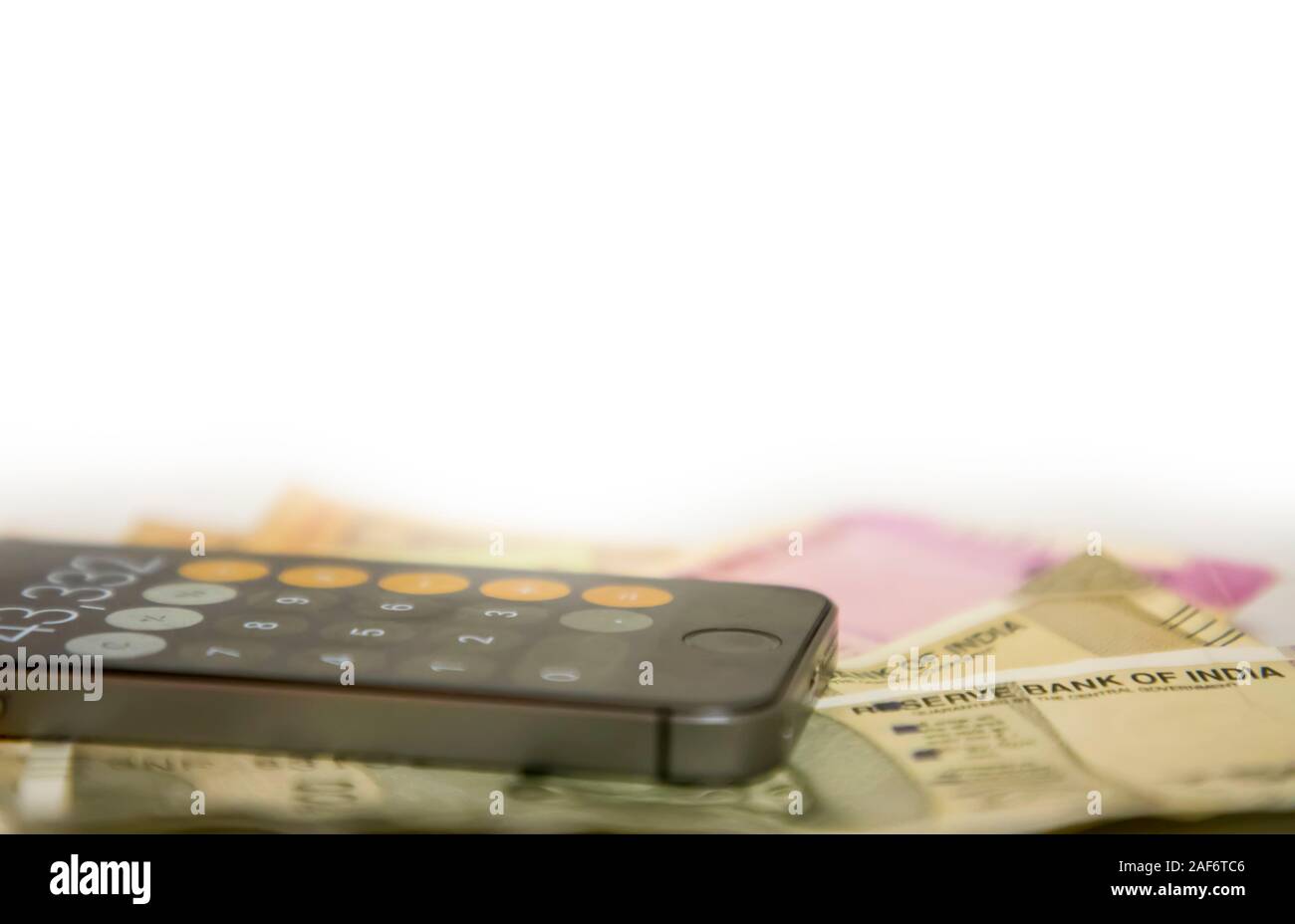 Mobile Phone and new Indian rupees banknotes on white background Stock ...