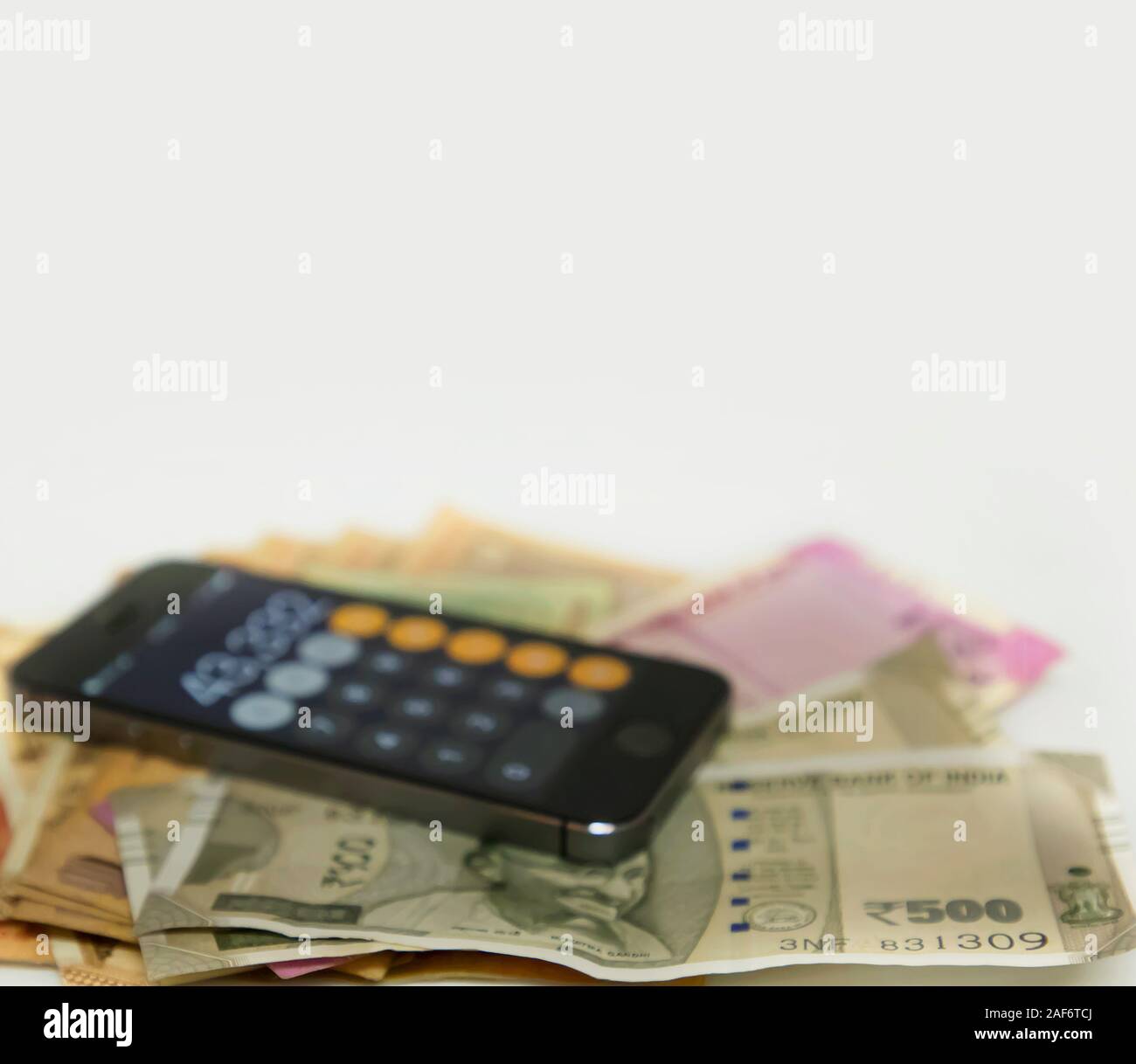 Mobile Phone and new Indian rupees banknotes on white background Stock ...