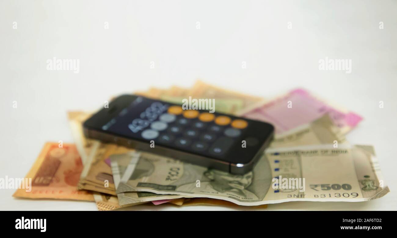Mobile Phone and new Indian rupees banknotes on white background Stock ...