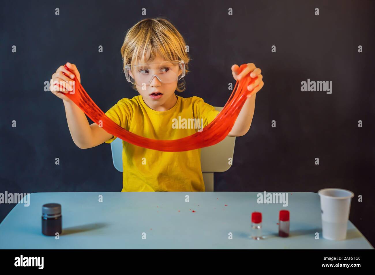 Boy playing hand made toy called slime. Child play with slime. Kid ...