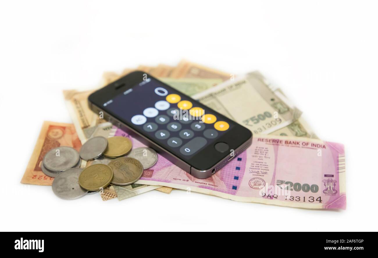 Close up view of Mobile Phone Calculate and new Indian rupees and coins ...