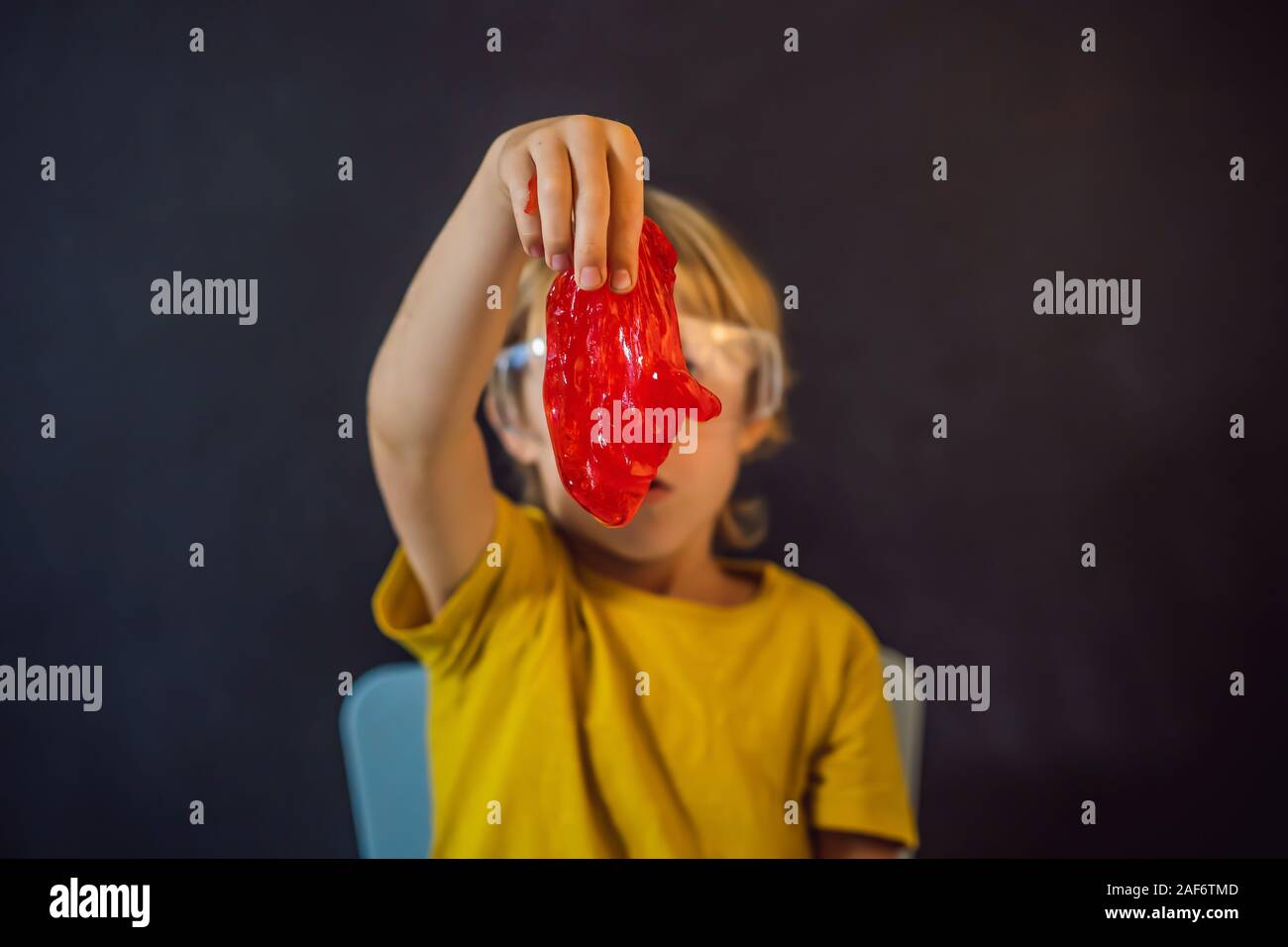Boy playing hand made toy called slime. Child play with slime. Kid ...