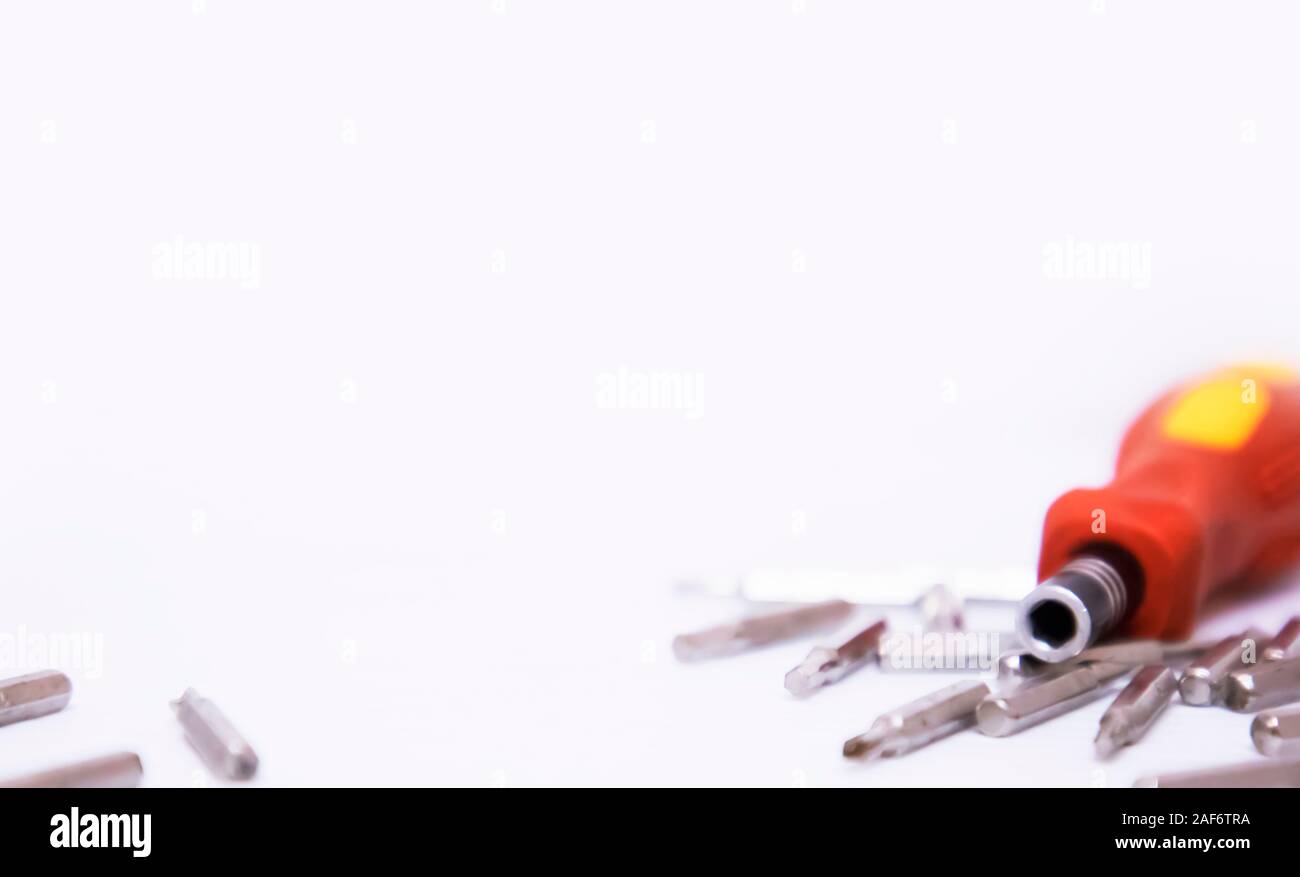 Yellow and red hand screwdrivers and screws isolated Stock Photo - Alamy
