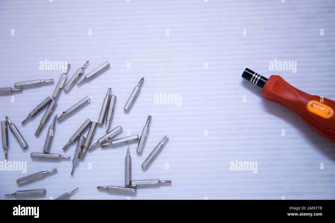 Yellow and red hand screwdrivers and screws isolated Stock Photo - Alamy