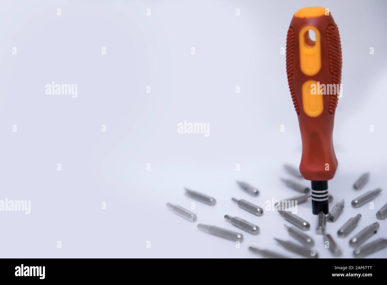 Yellow and red hand screwdrivers and screws isolated Stock Photo - Alamy