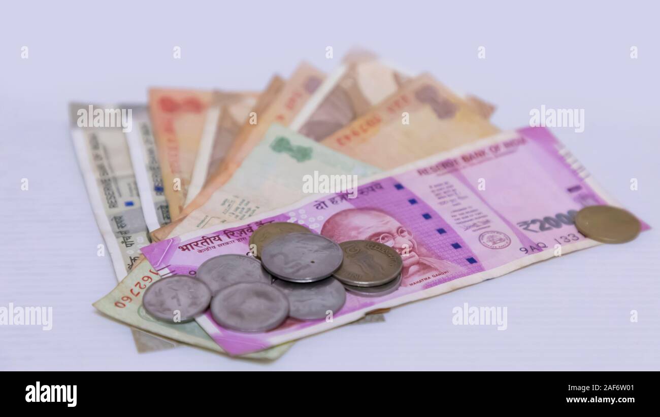 Indian currency bank notes of 500 and 2000 rupees with coins - white ...