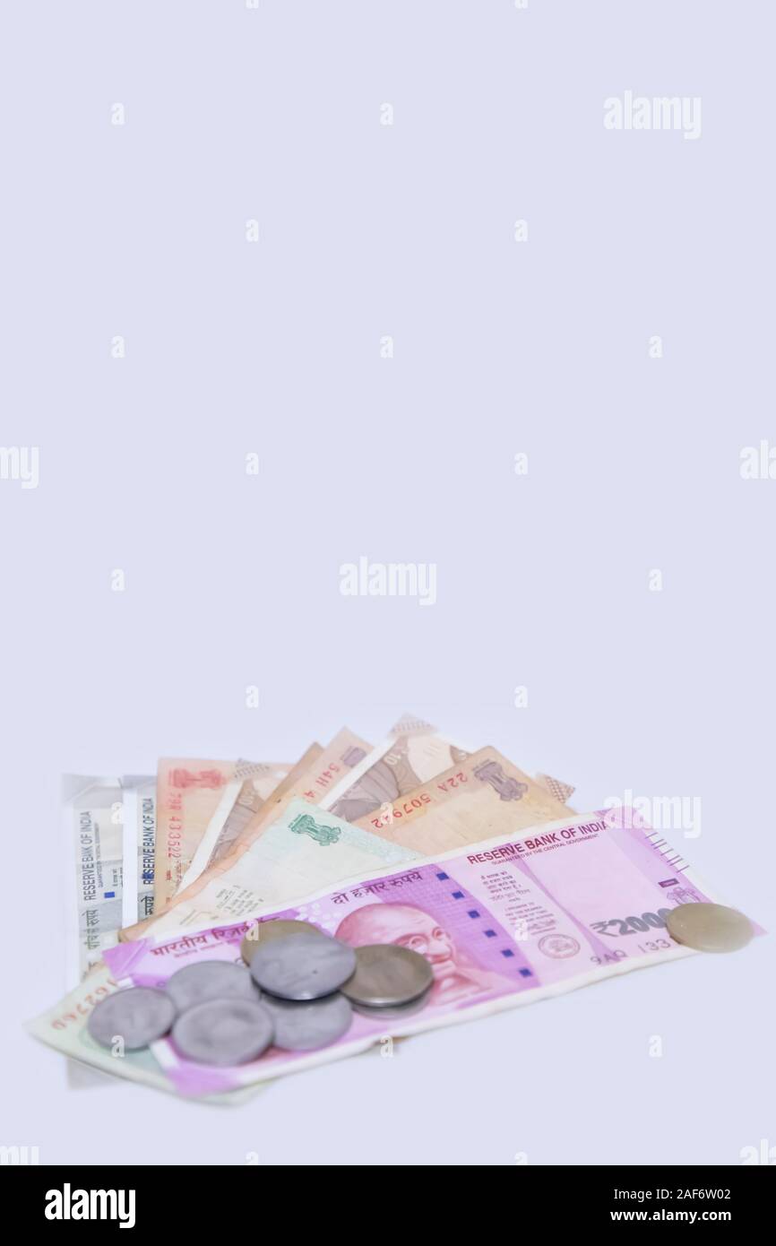 Indian currency bank notes of 500 and 2000 rupees with coins - white ...
