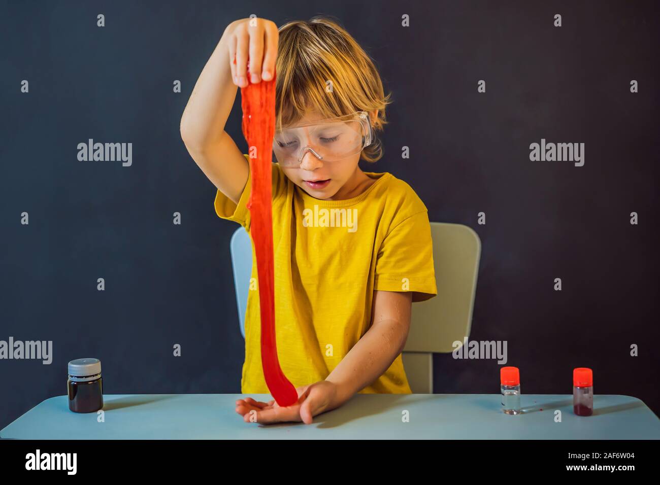 Boy playing hand made toy called slime. Child play with slime. Kid ...