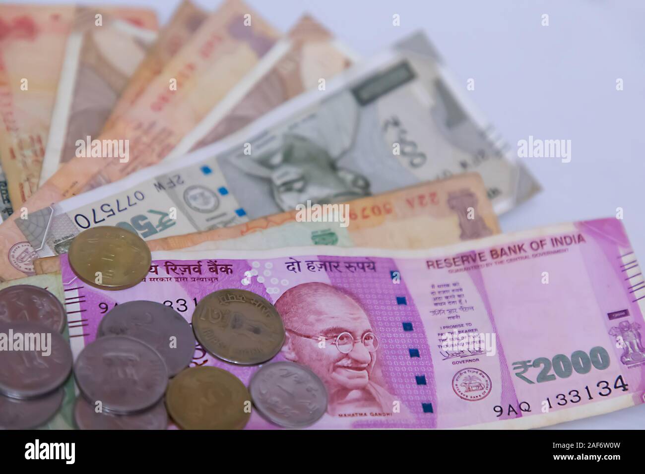 Indian currency bank notes of 500 and 2000 rupees with coins - white ...