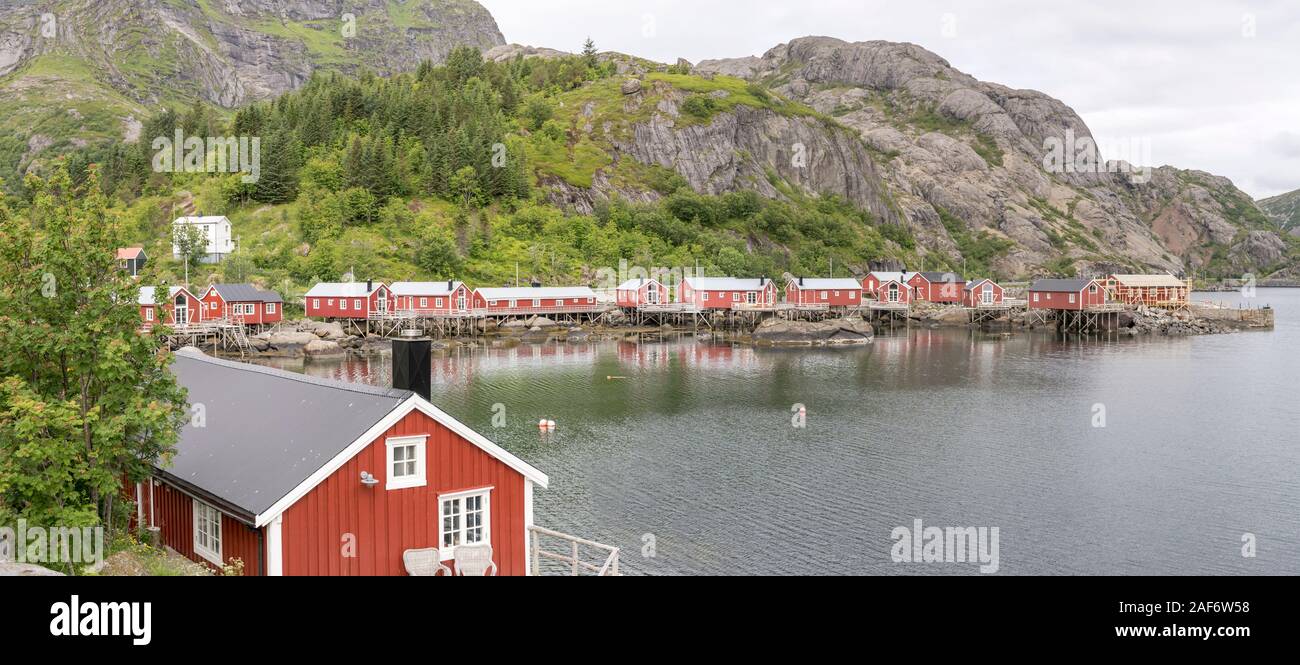 Arctic circle fjord cityscape with traditional stilt rorbuer at inlet ...
