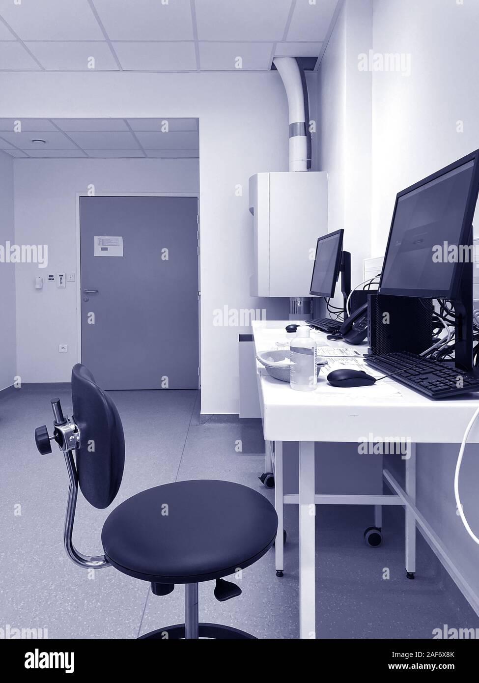 Hospital facility room with two computers and clean yellow floor Stock ...