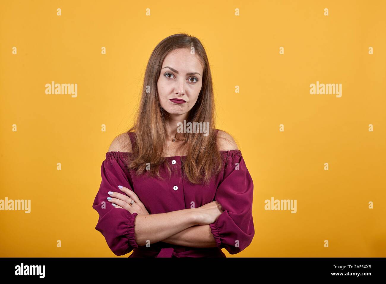 Young woman looks angry and folding her armes Stock Photo - Alamy