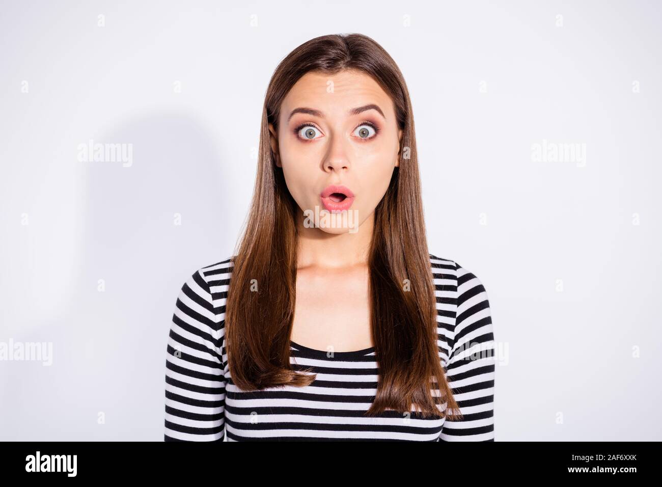 Portrait of frustrated lady looking at camera wearing striped pullover ...