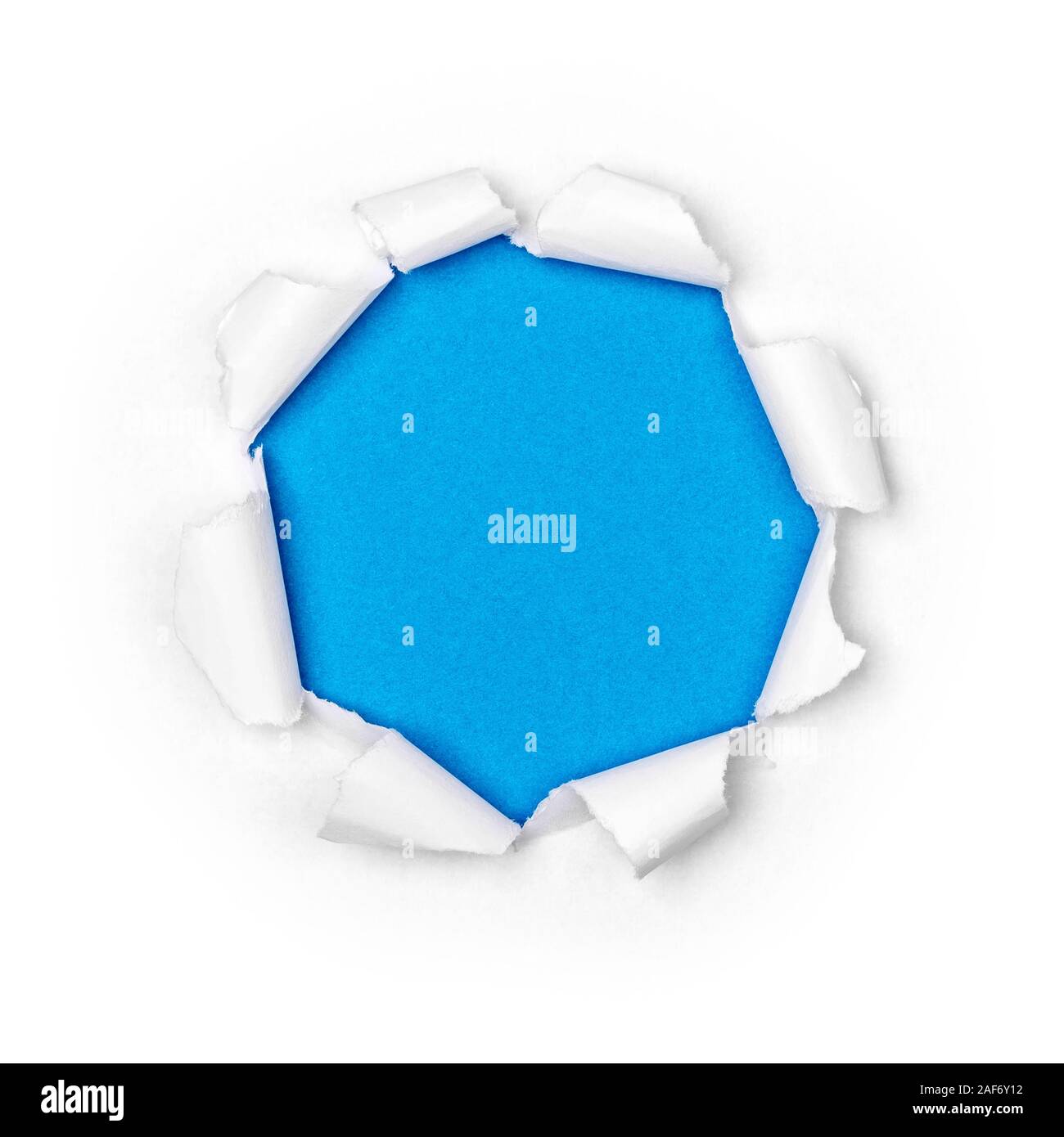 Paper hole in white paper with ragged edges with blue background Stock ...