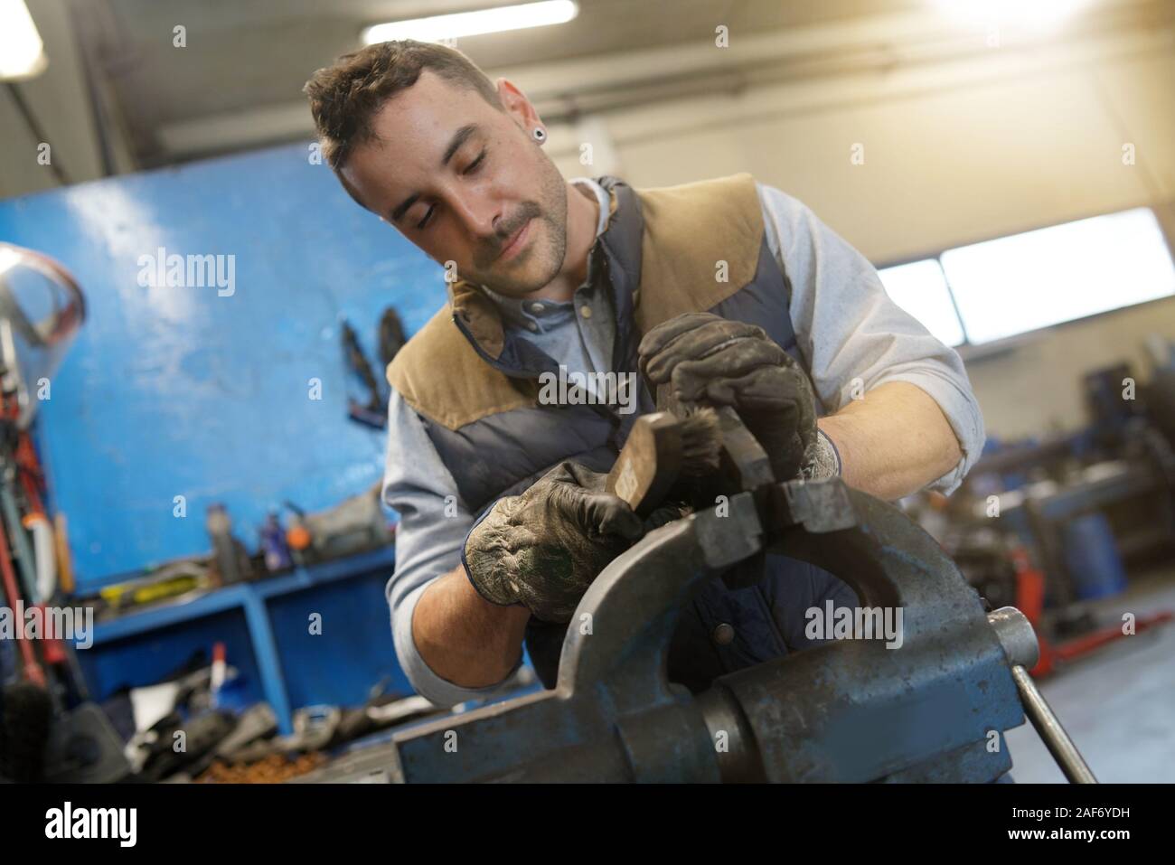 Mechanical employee working in workshop Stock Photo - Alamy