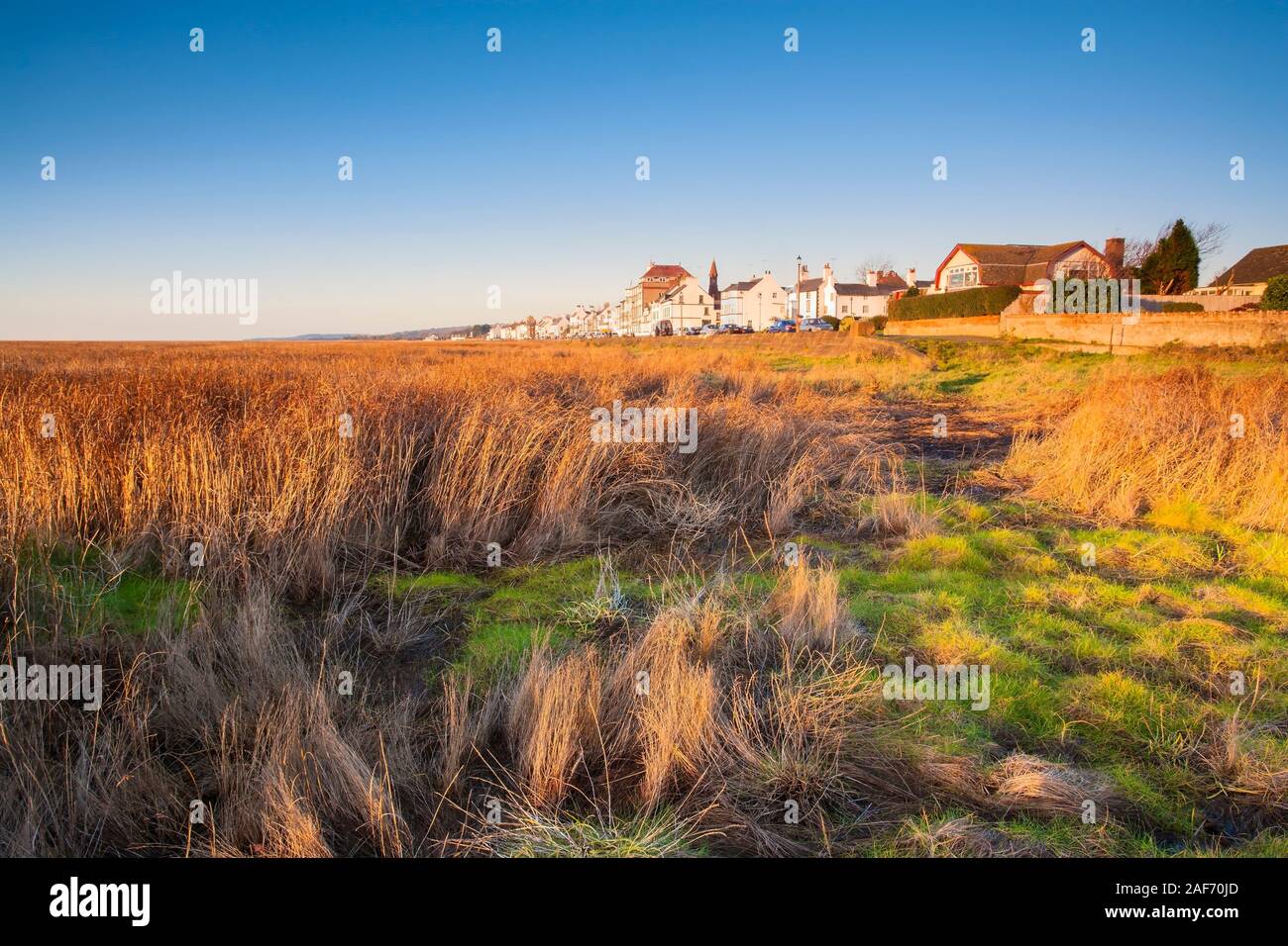 A sunny view across marsh land of Parkgate on the Wirral Peninsula ...