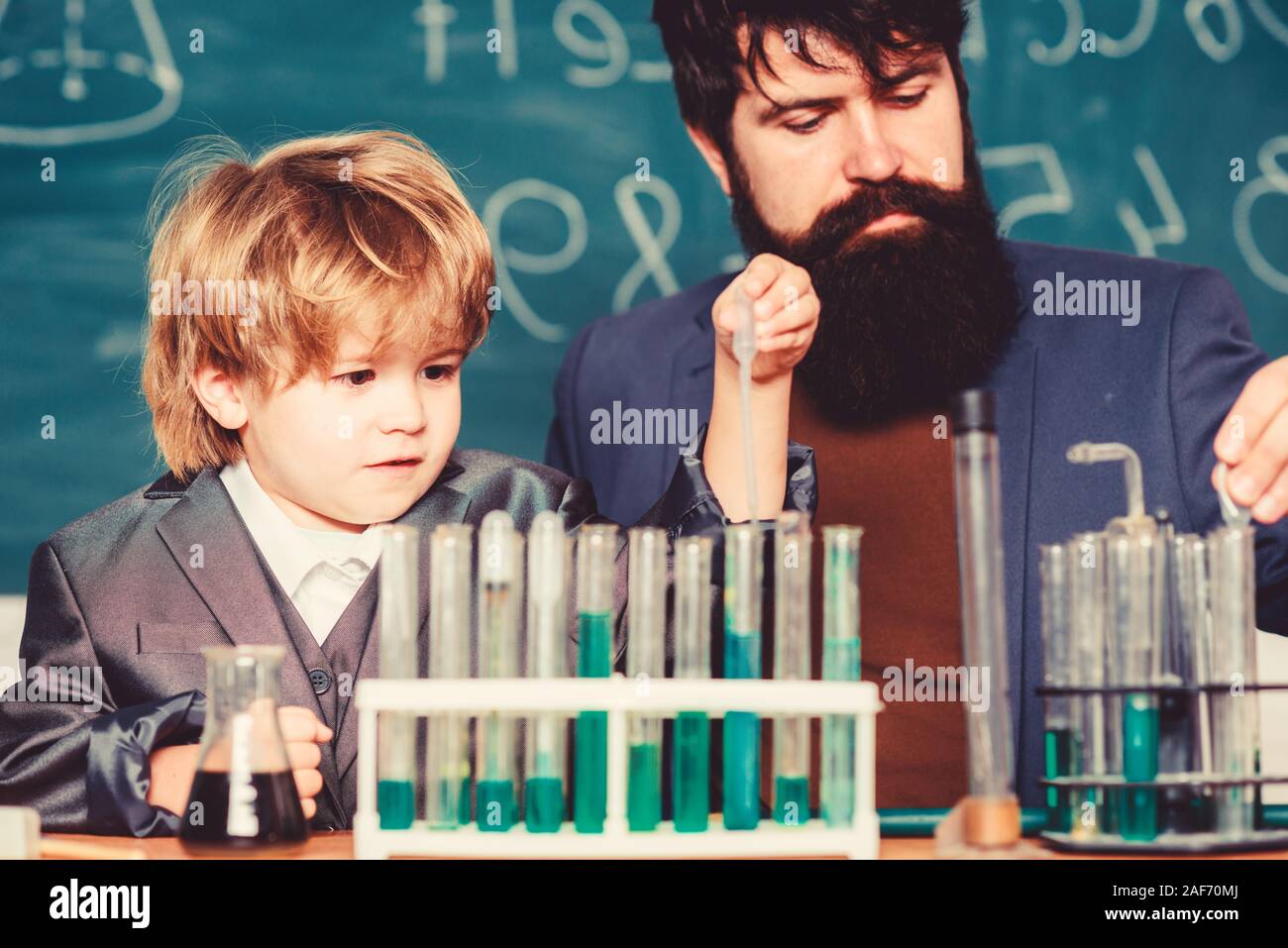 Cognitive skills. Chemistry experiment. Teacher child test tubes ...