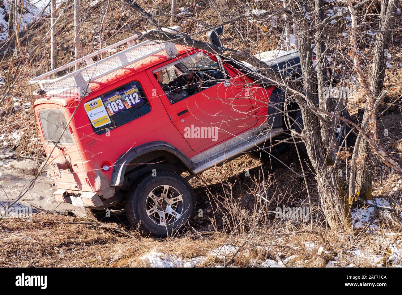 Jeep Suzuki Jimny overcomes obstacles in the forest Stock Photo - Alamy