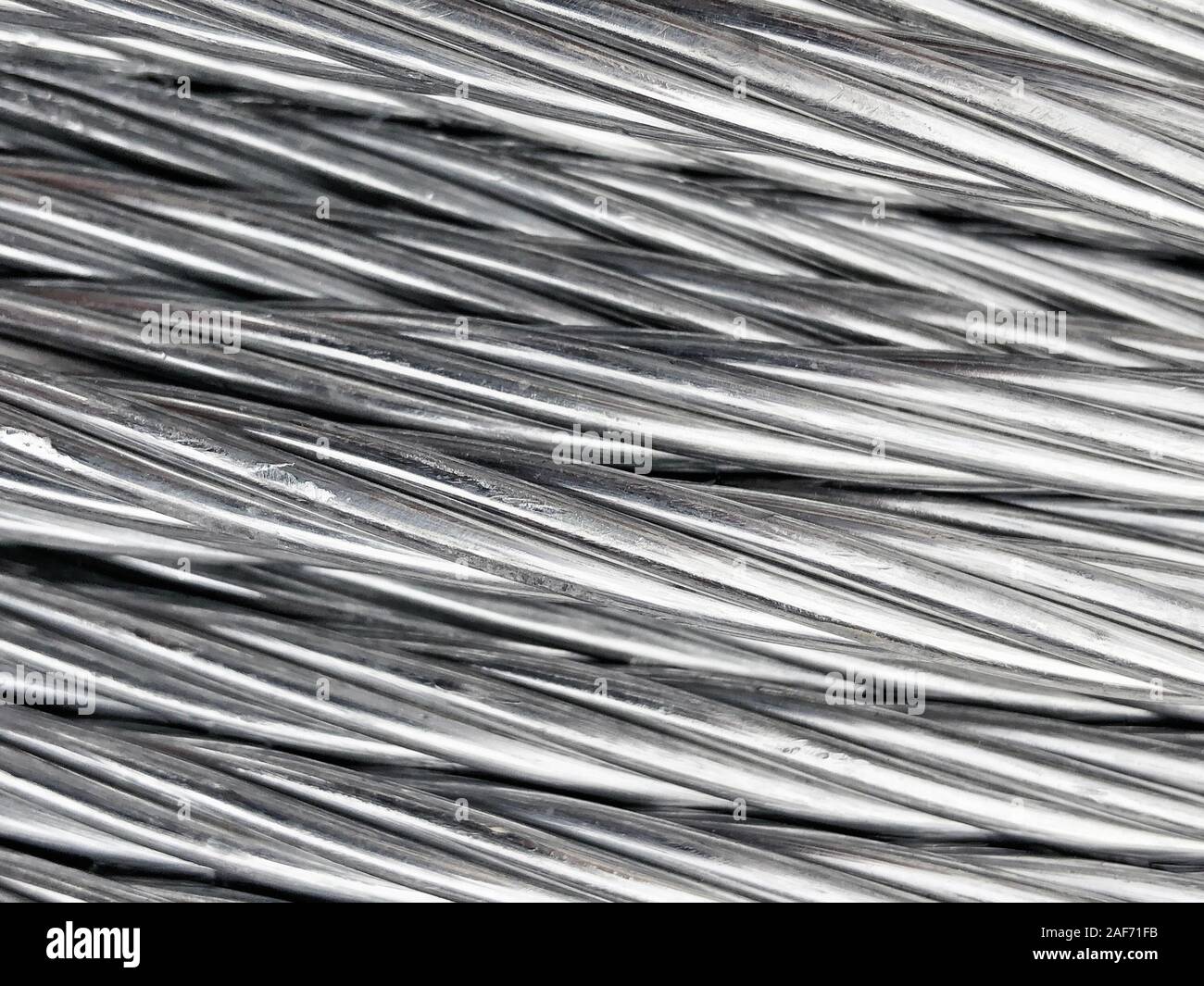 Close up of coiled metal cable industrial background Stock Photo - Alamy
