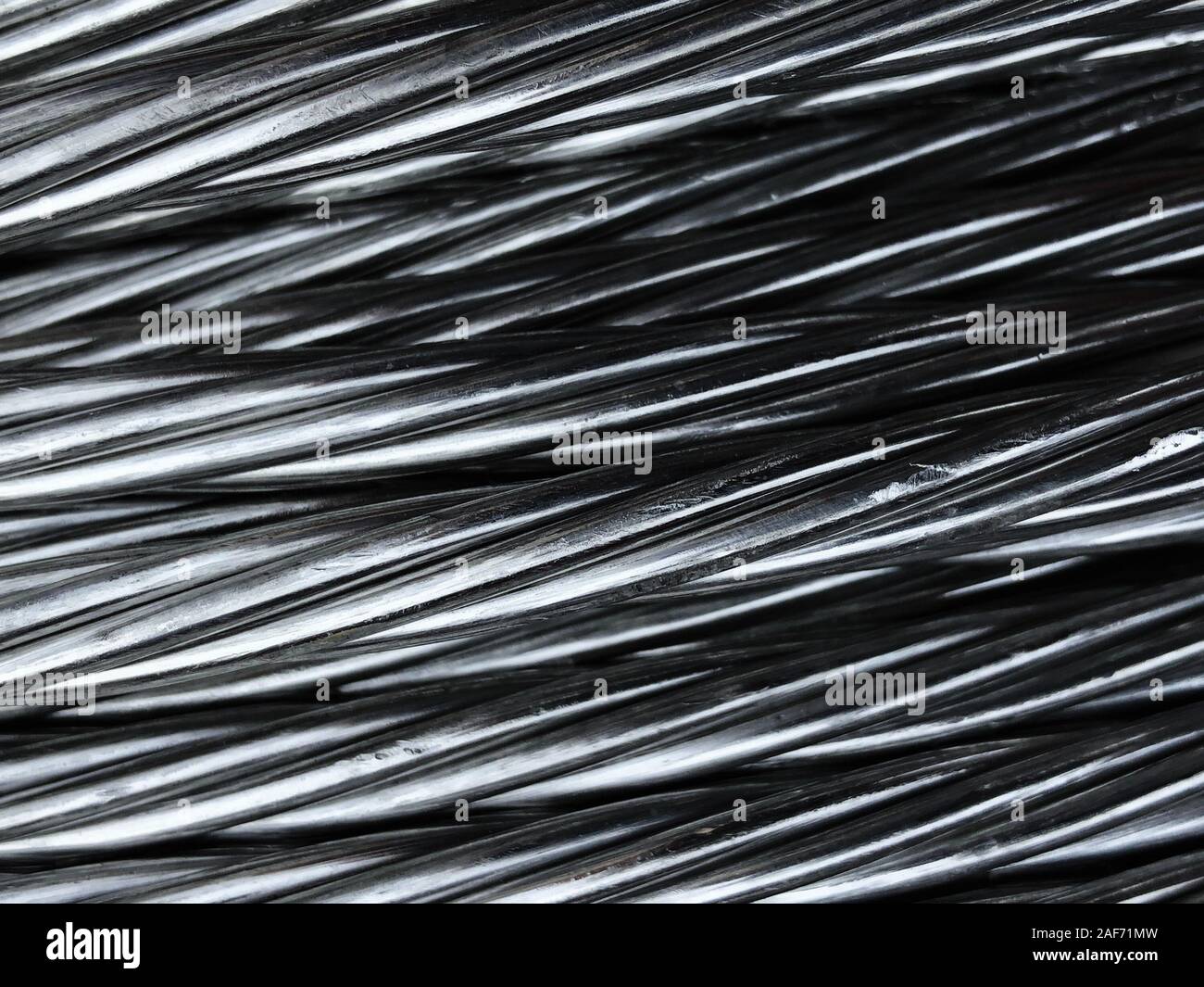 Close up of coiled metal cable industrial background Stock Photo - Alamy