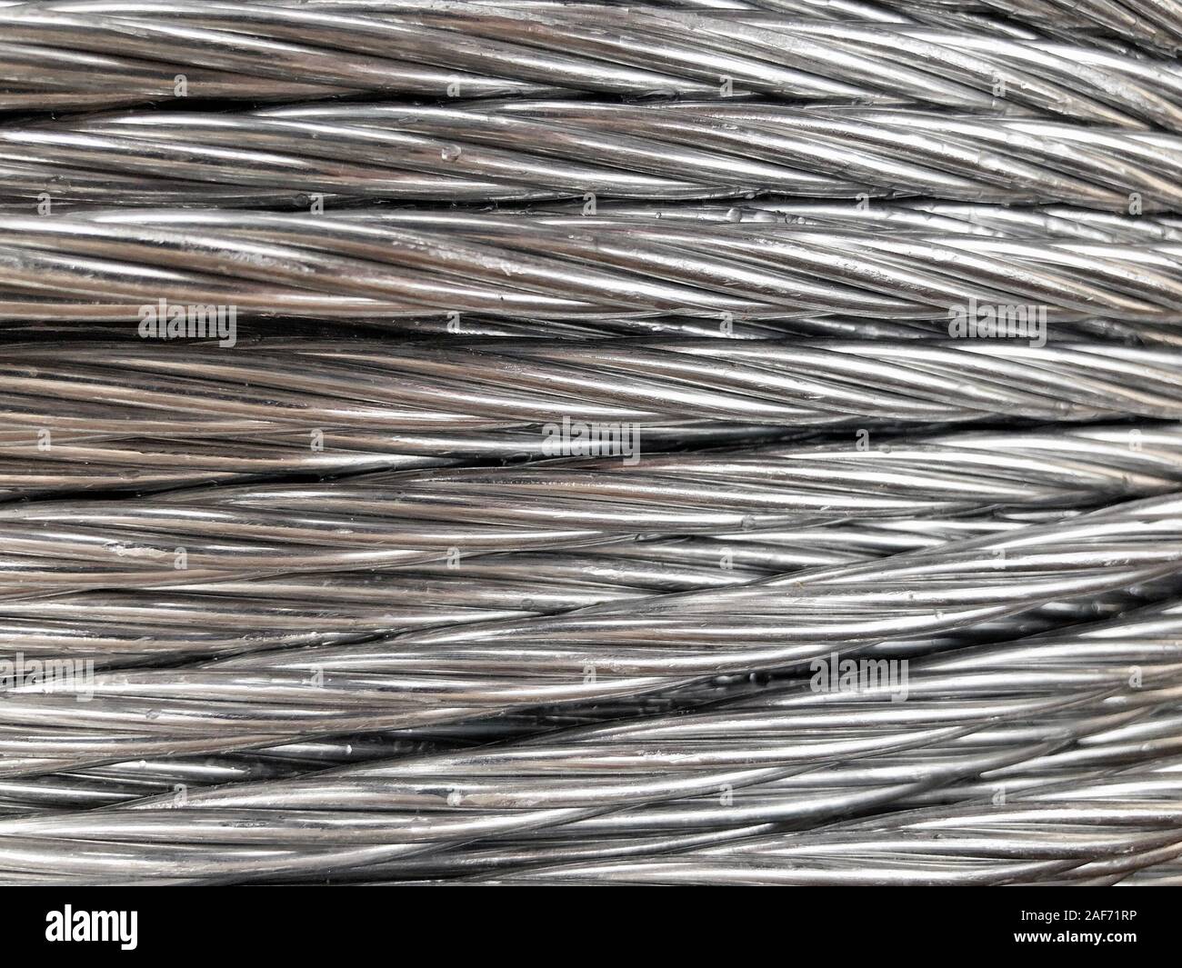 Close up of coiled metal cable industrial background Stock Photo - Alamy