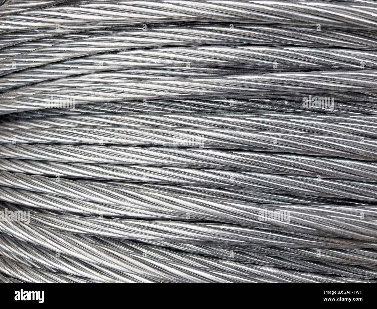 Close up of coiled metal cable industrial background Stock Photo - Alamy