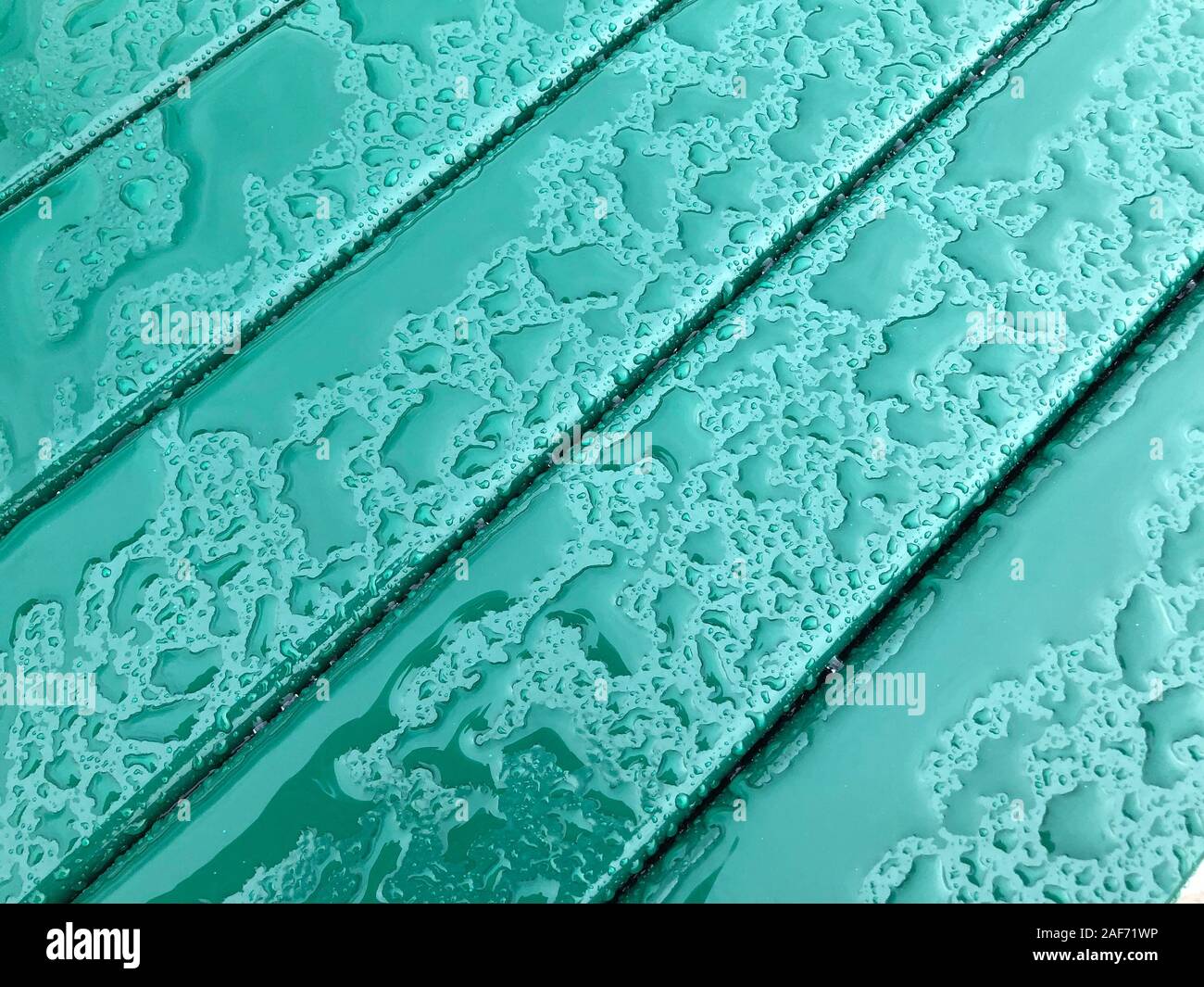 Rain drops on green colored metal surface Stock Photo - Alamy