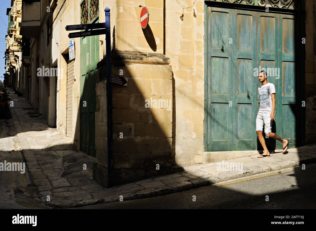 Young man walking on the street in Valletta, Malta Stock Photo - Alamy