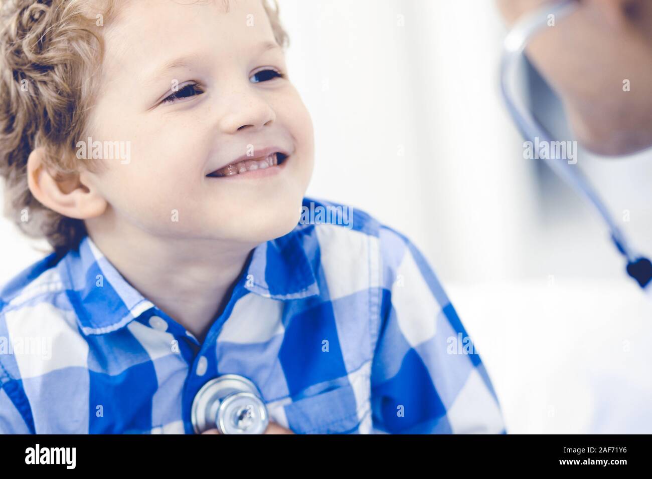 Doctor and patient child. Physician examining little boy. Regular ...