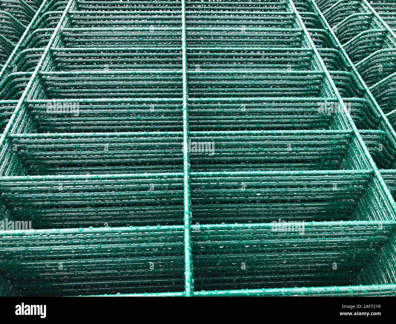 Rain drops on green colored metal grid Stock Photo - Alamy