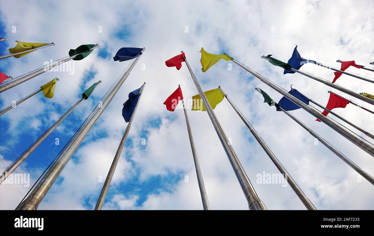 Colorful flags under the blue sky and white clouds Stock Photo - Alamy