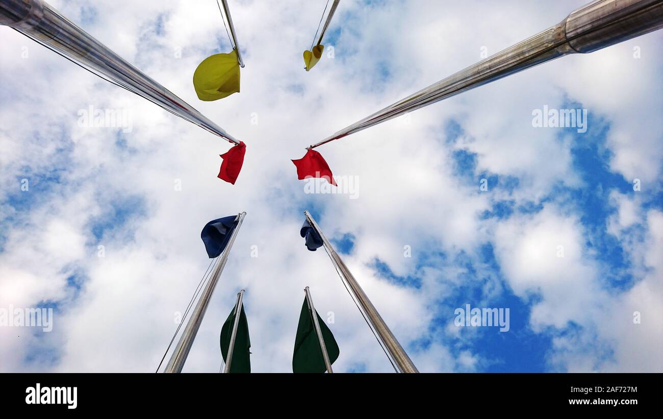 Colorful flags under the blue sky and white clouds Stock Photo - Alamy