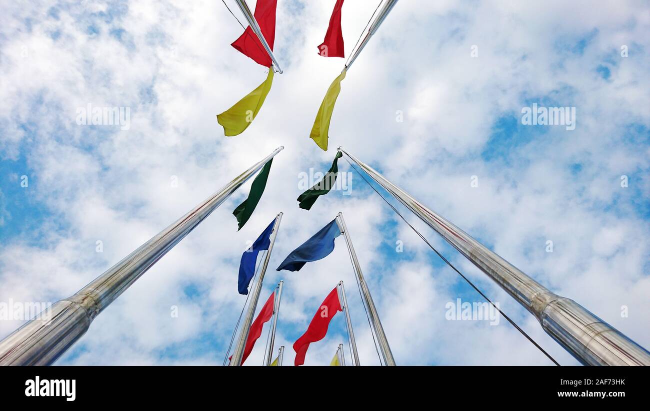 Colorful flags under the blue sky and white clouds Stock Photo - Alamy